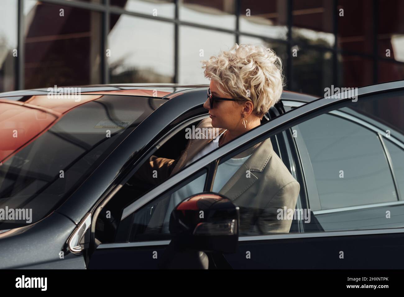 Elegant Woman Driver Getting in the Luxury Car Stock Photo - Alamy