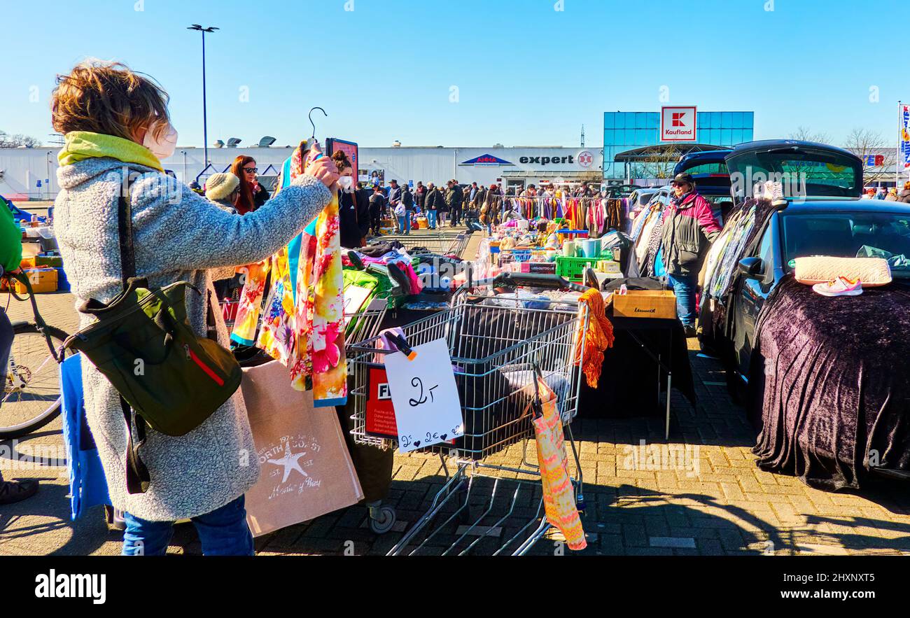Gifhorn, Germany, March 13, 2022: Buyer at the flea market examines a ...