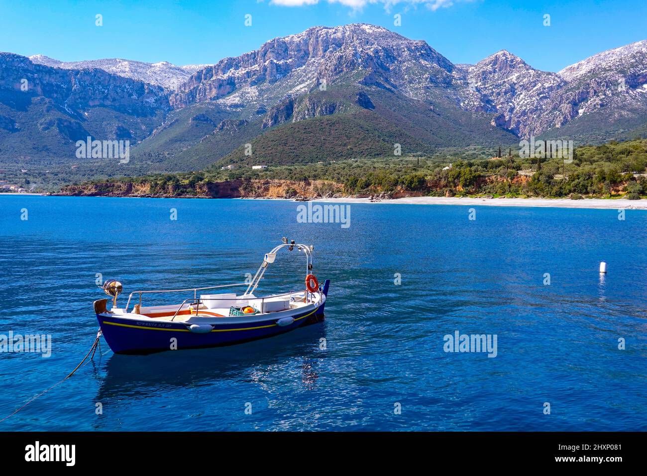 Small blue rowing boat at the small isolated village of Kyparissi in ...