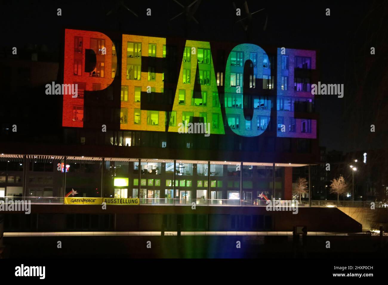 Peace Projection on Headquarter Greenpeace Germany Stock Photo - Alamy