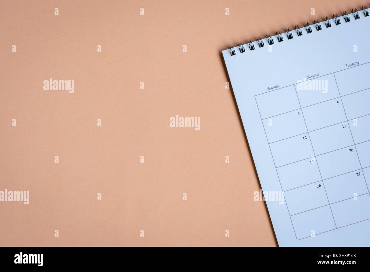 White clean calendar on beige background with copy space. Business ...