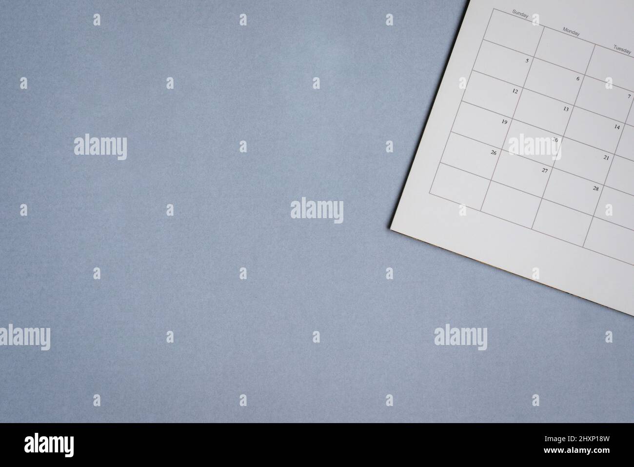 White clean calendar on blue gray background. Project schedule, travel ...