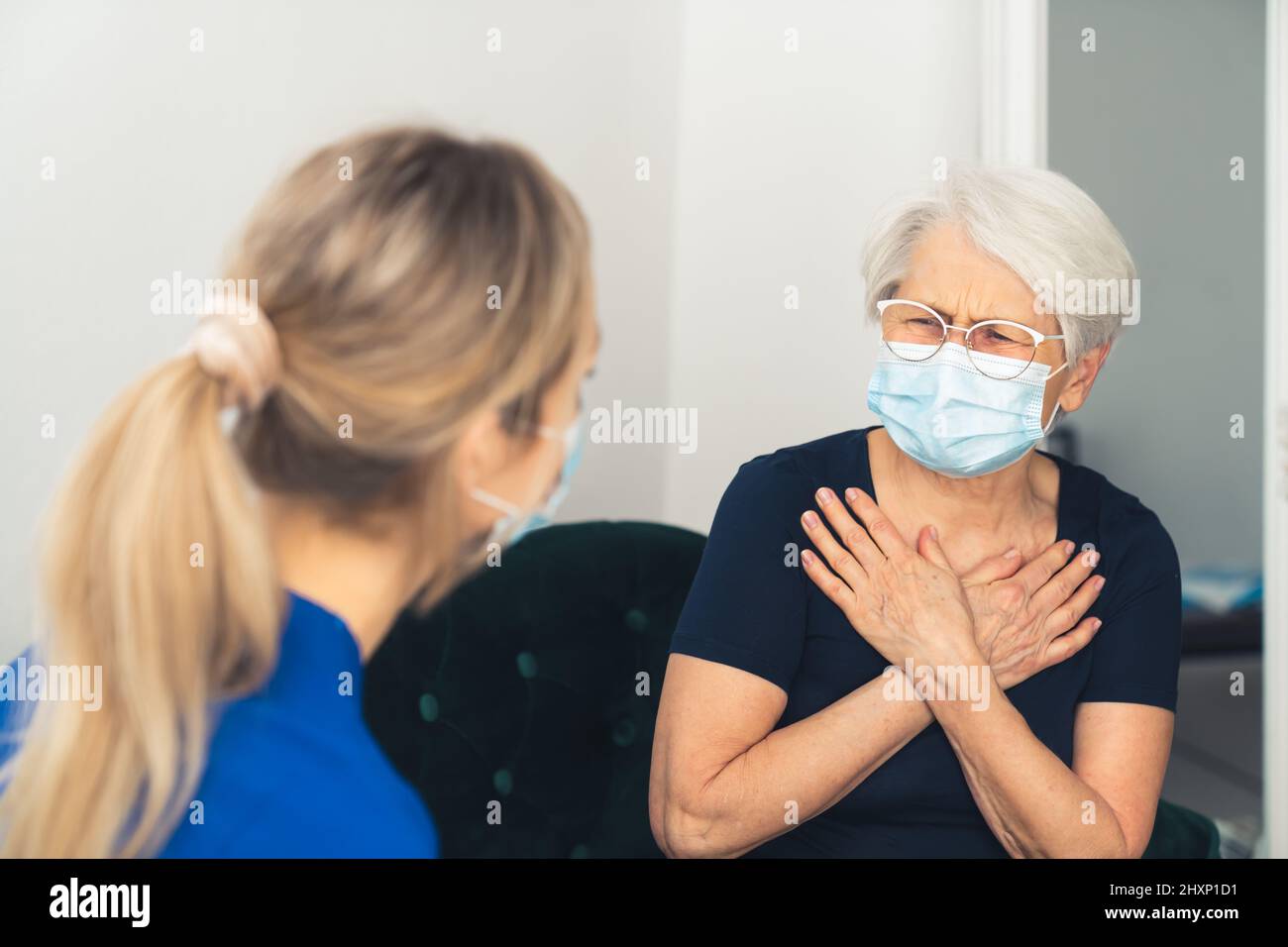 Elderly lady feeling bad and sick, touching her chest, and complaining ...