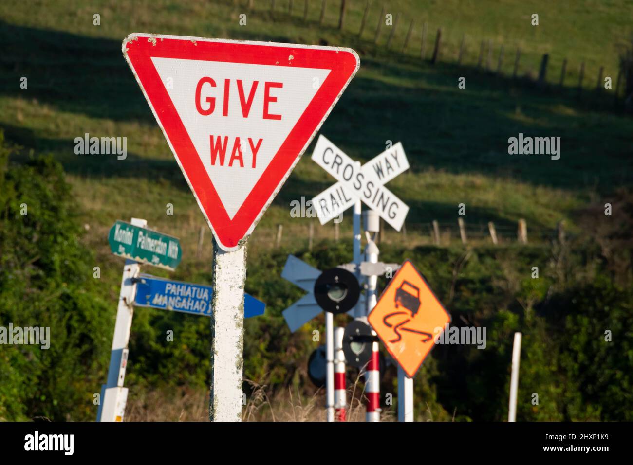 Road signs at intersection and railway crossing near Pahiatua, Tararua ...