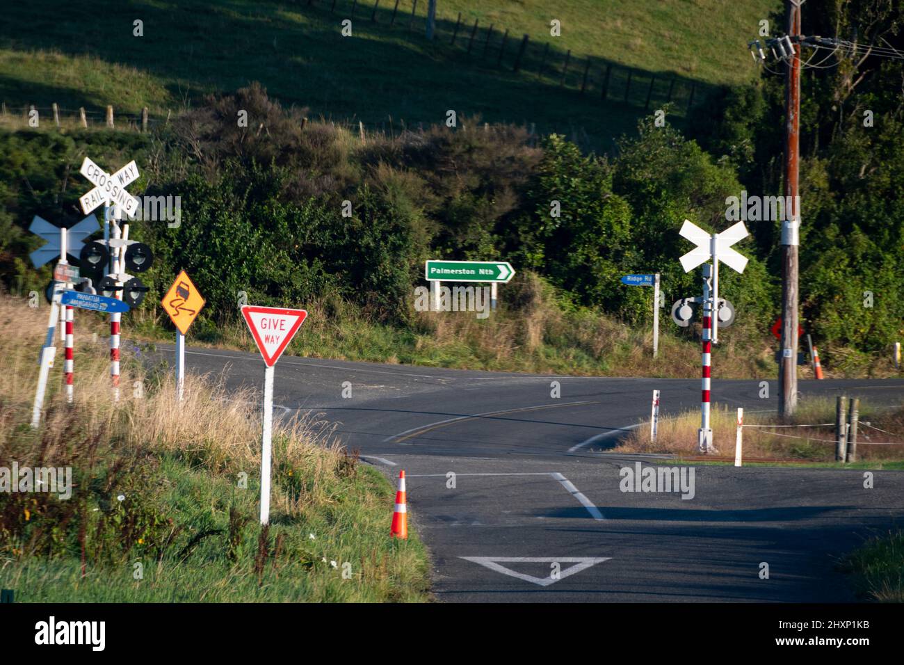 Road signs at intersection and railway crossing near Pahiatua, Tararua ...