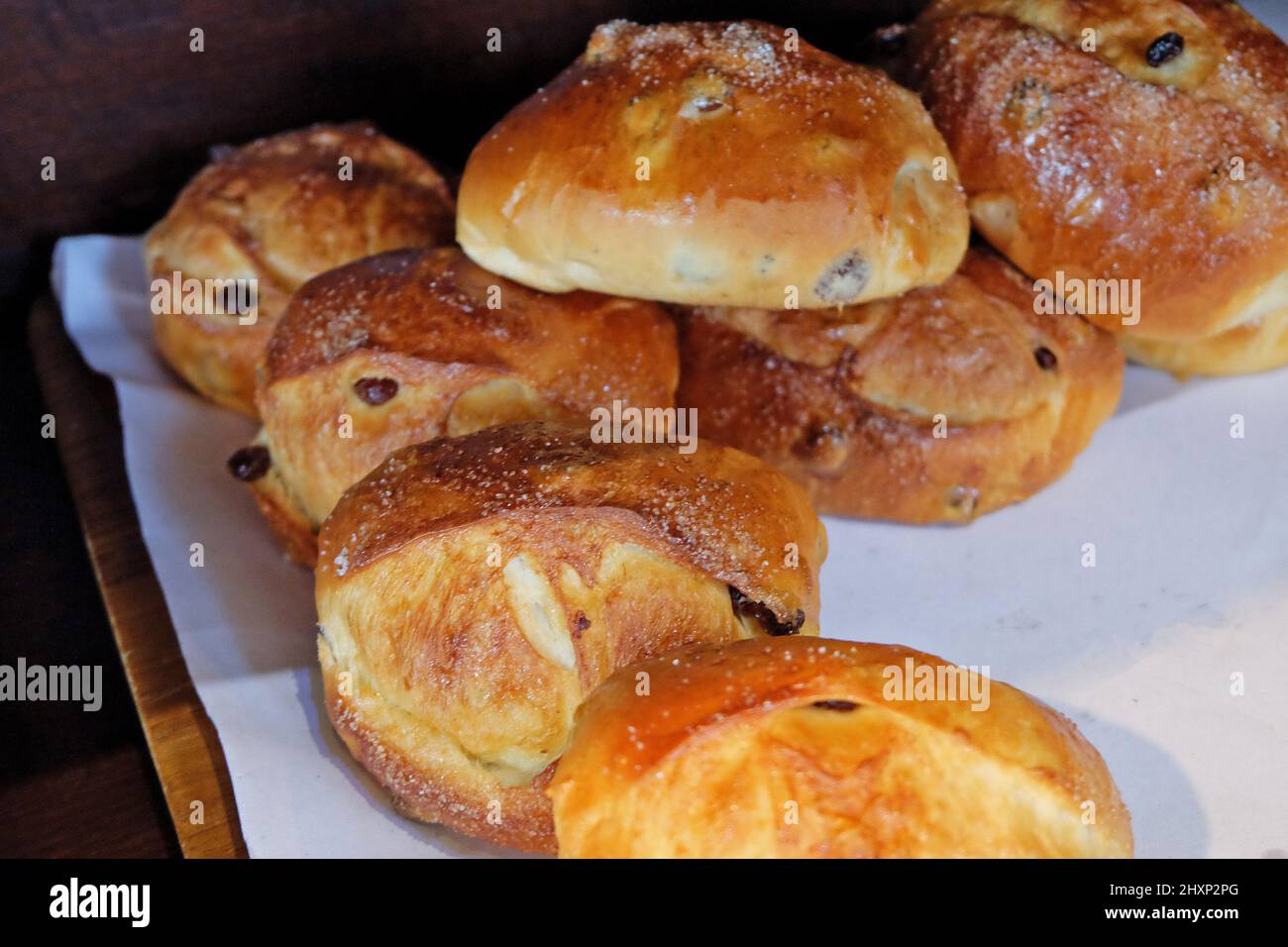 Assorted bakery bun and butter pastry displayed on retail shelf- Danish ...
