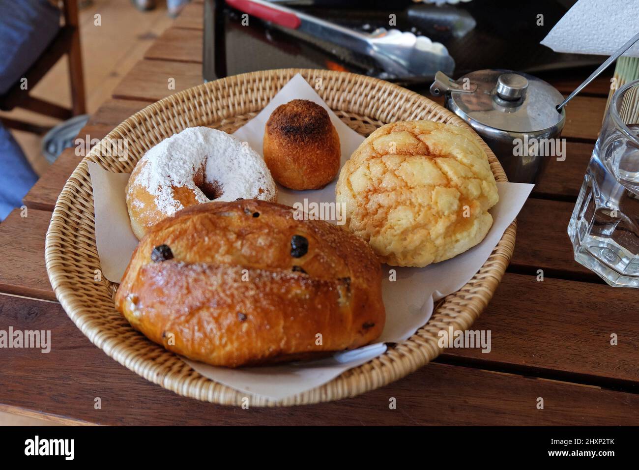 Assorted bakery bun and butter pastry displayed on retail shelf- Danish ...
