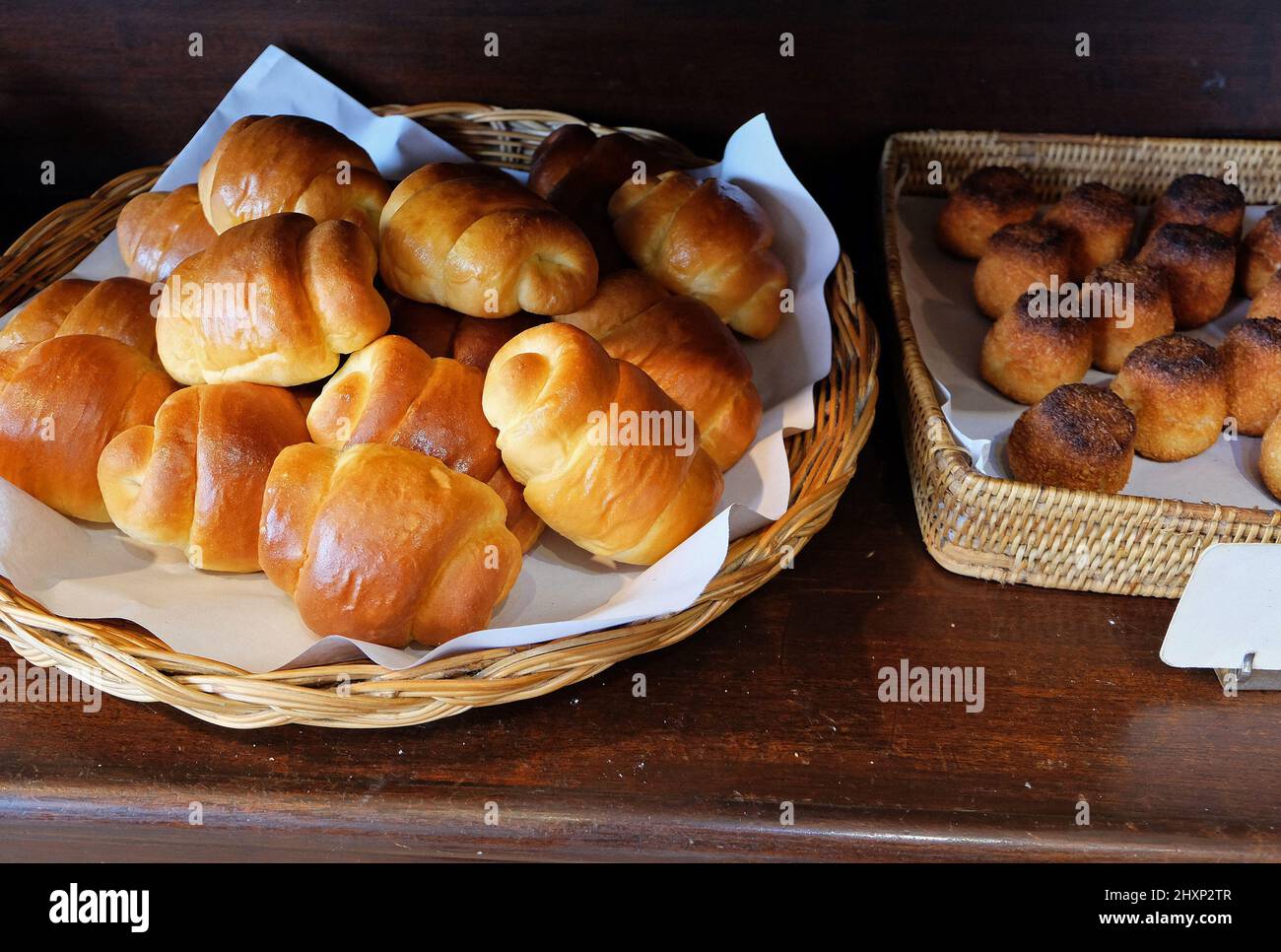Assorted bakery bun and butter pastry displayed on retail shelf- Danish ...