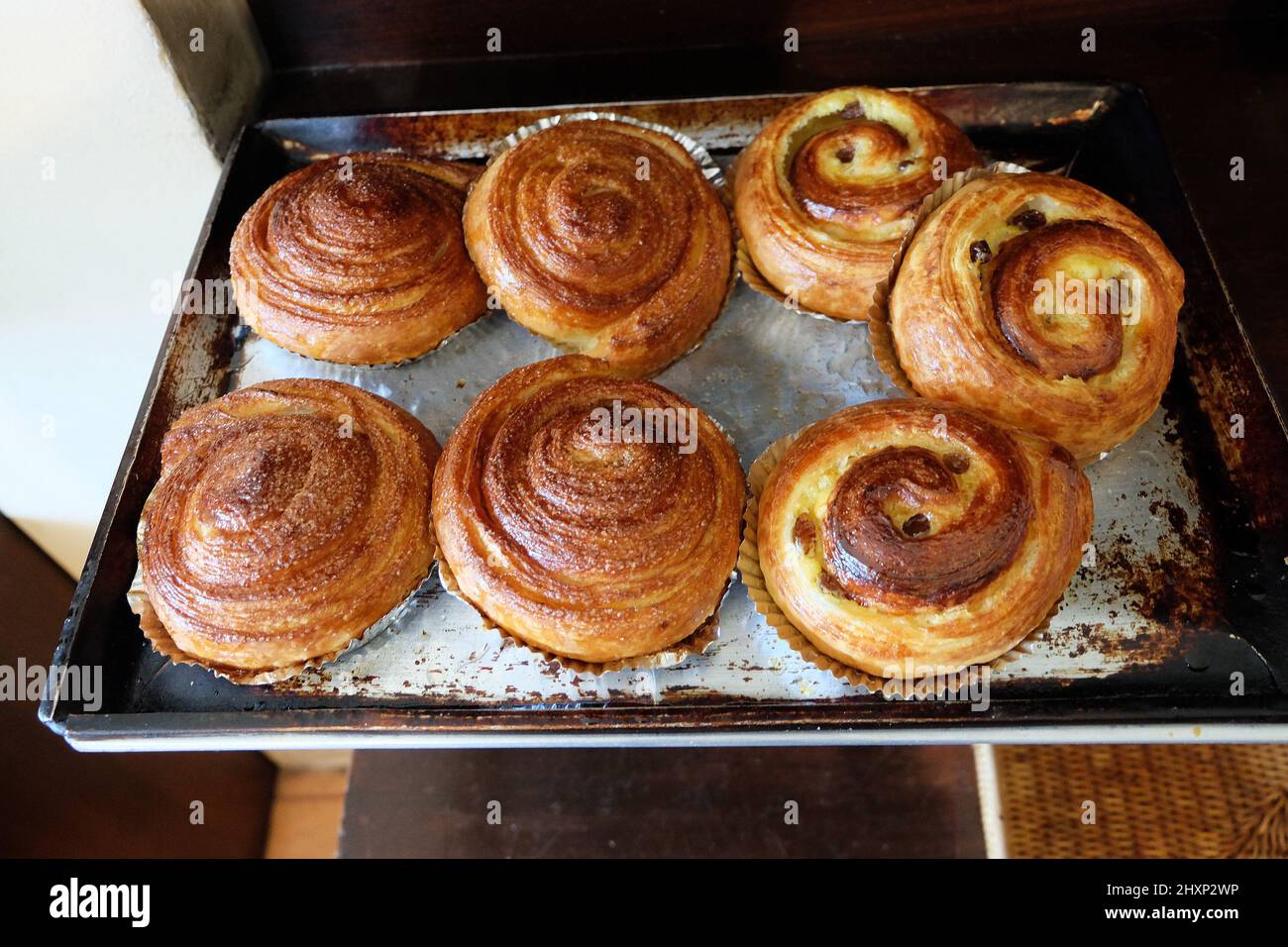 Assorted bakery bun and butter pastry displayed on retail shelf- Danish ...