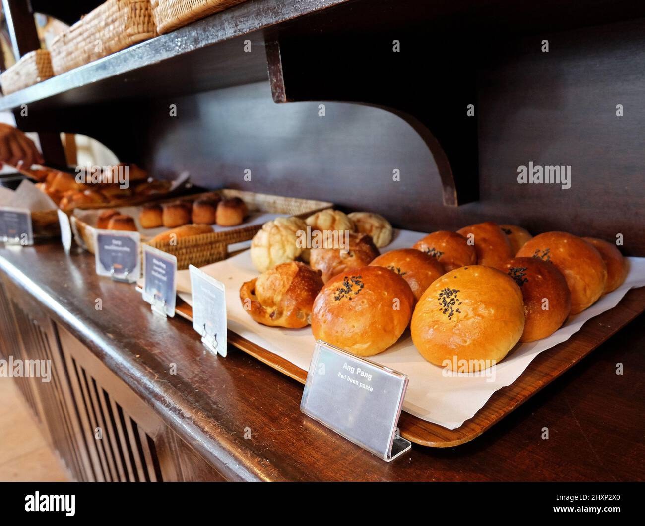 Assorted bakery bun and butter pastry displayed on retail shelf- Danish ...