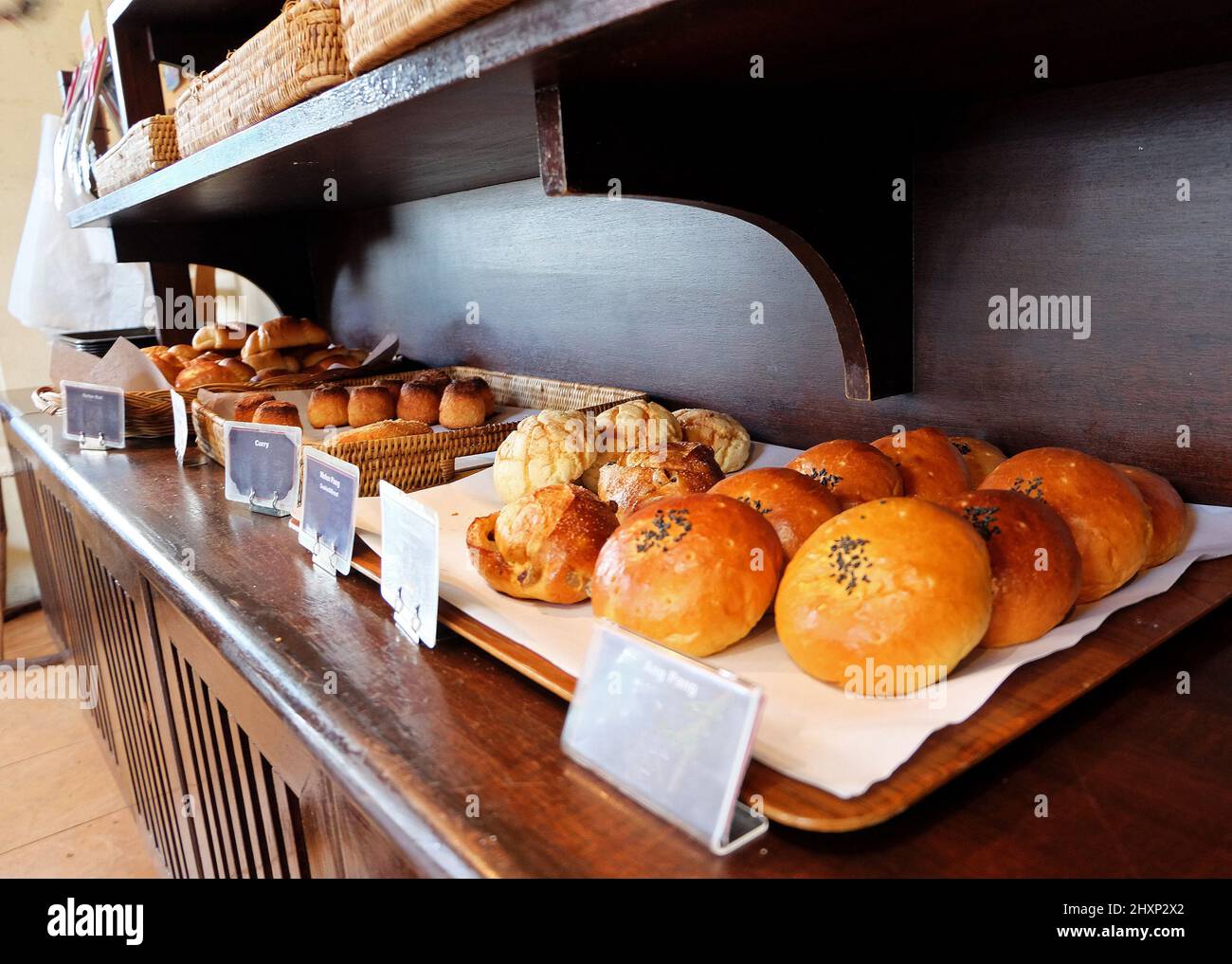 Assorted bakery bun and butter pastry displayed on retail shelf- Danish ...