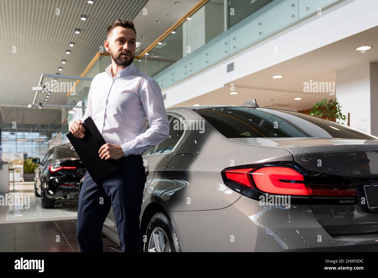 Successful car dealership manager tablet hi-res stock photography and ...