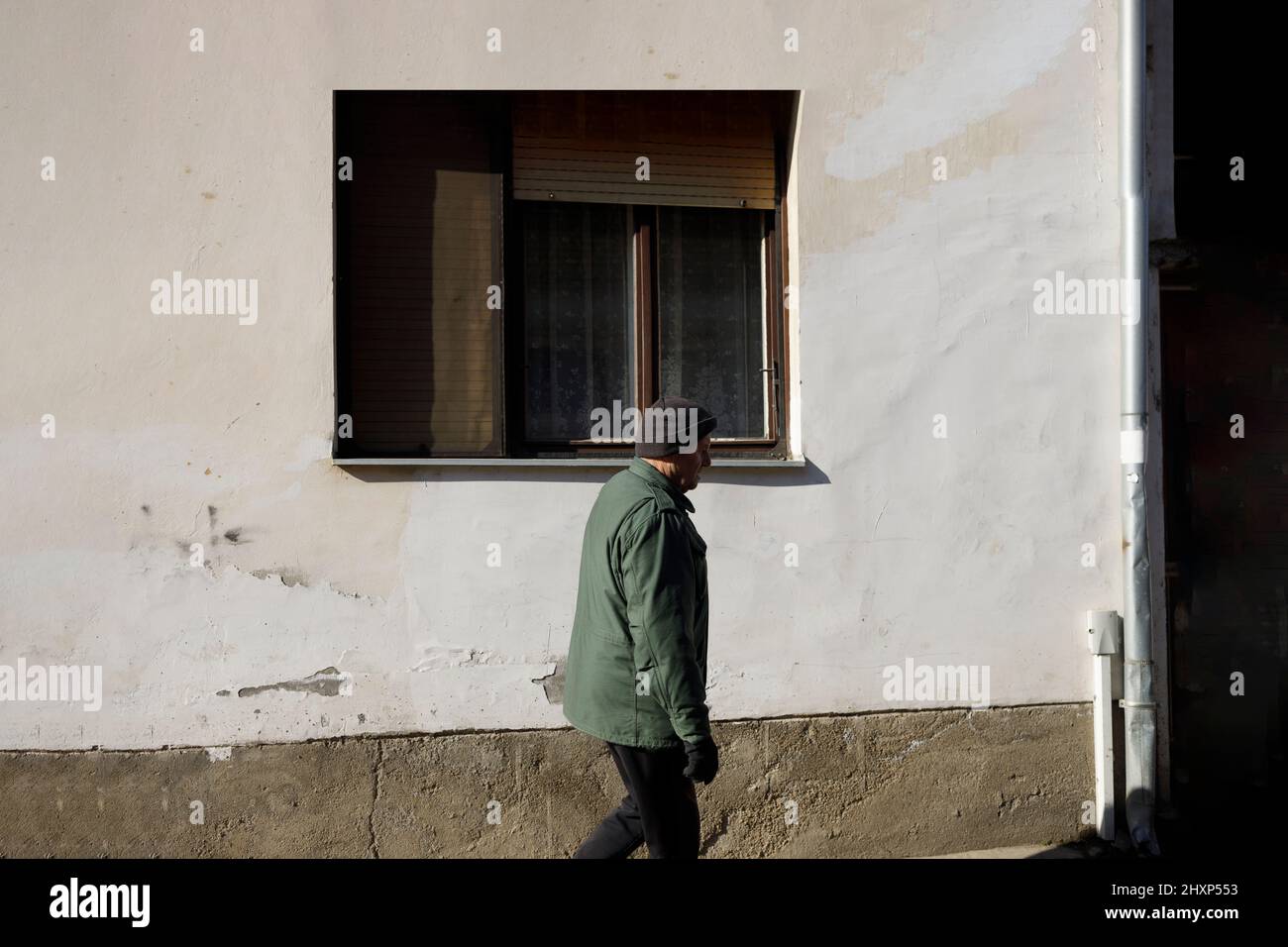 Poor man walking through the poor neighborhood Stock Photo - Alamy