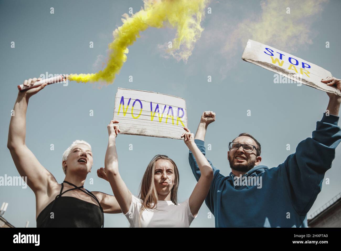 Group of young people with posters going to rally, strike against war ...