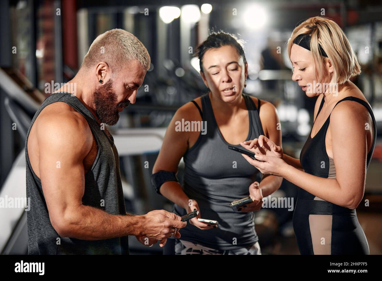 Fitness Gym friend exercising in the gym, team work and togetherness ...