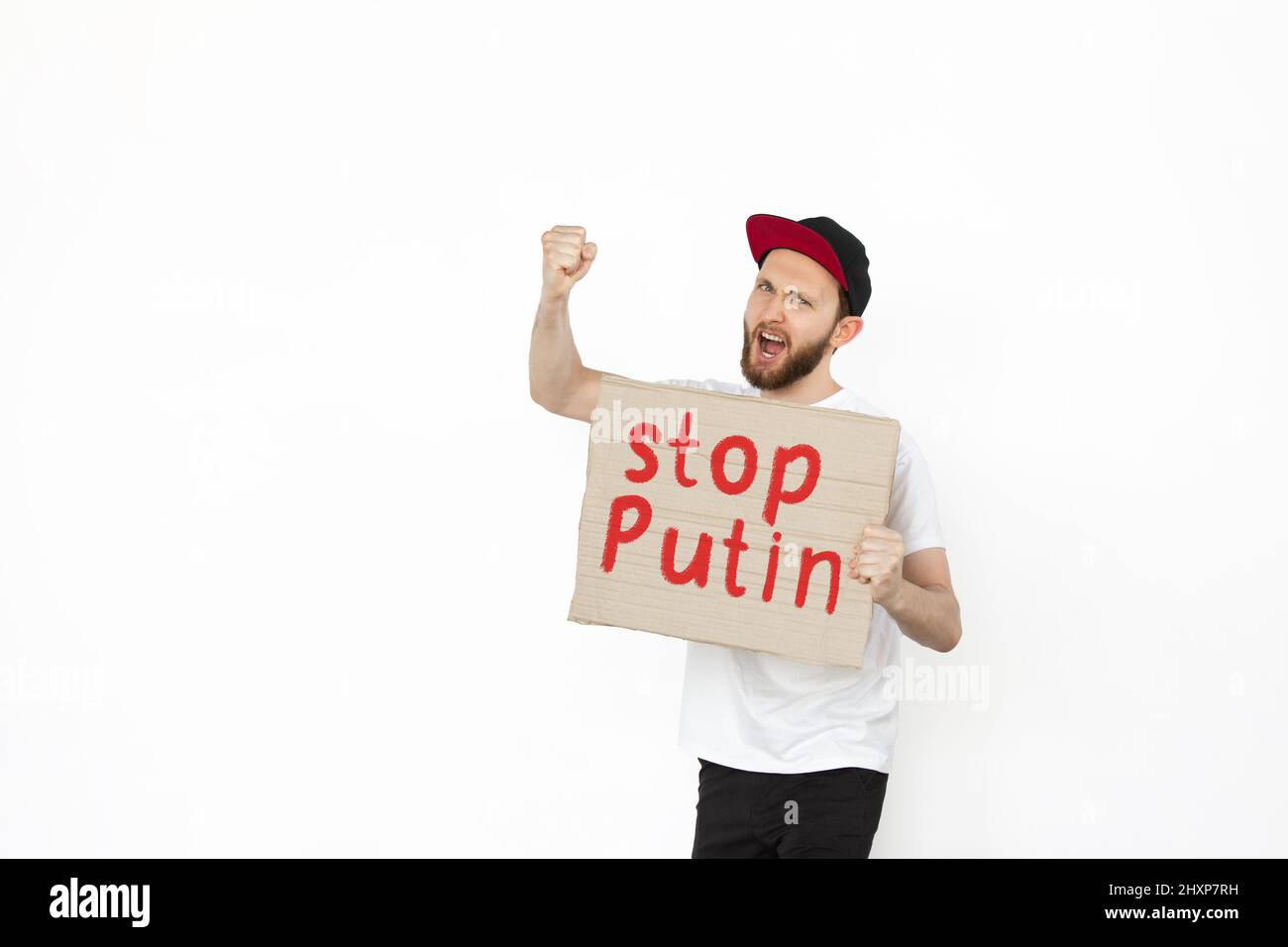 Conceptual portrait of emotional young man shouting, holding poster ...