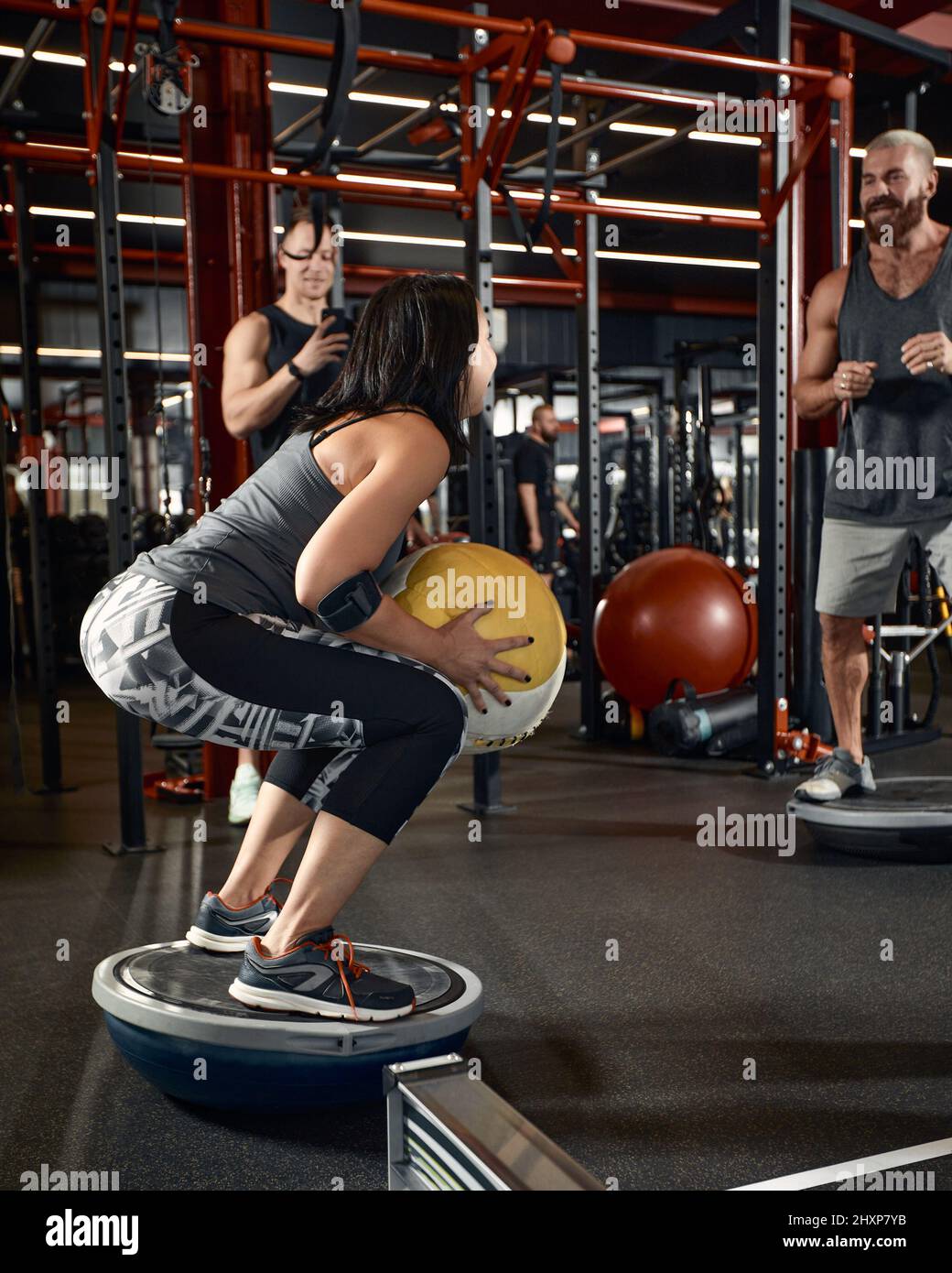 The guys tries to keep his balance on the balancing platform with ...