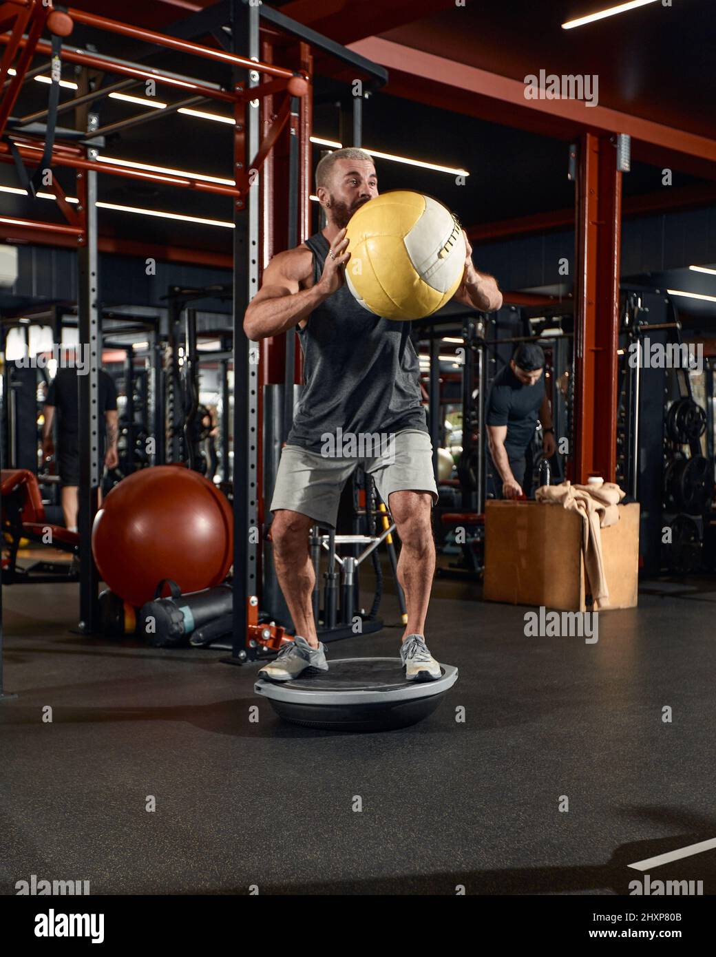 The guys tries to keep his balance on the balancing platform with ...