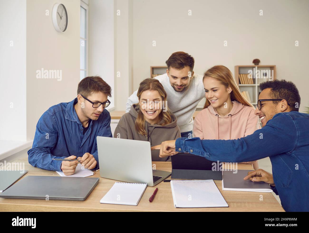 University students using a laptop computer while working on their ...