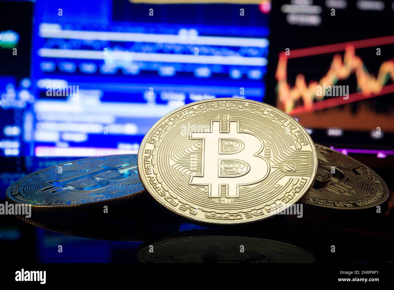 Bitcoin gold coin and unfocused chart background. Virtual crypto ...