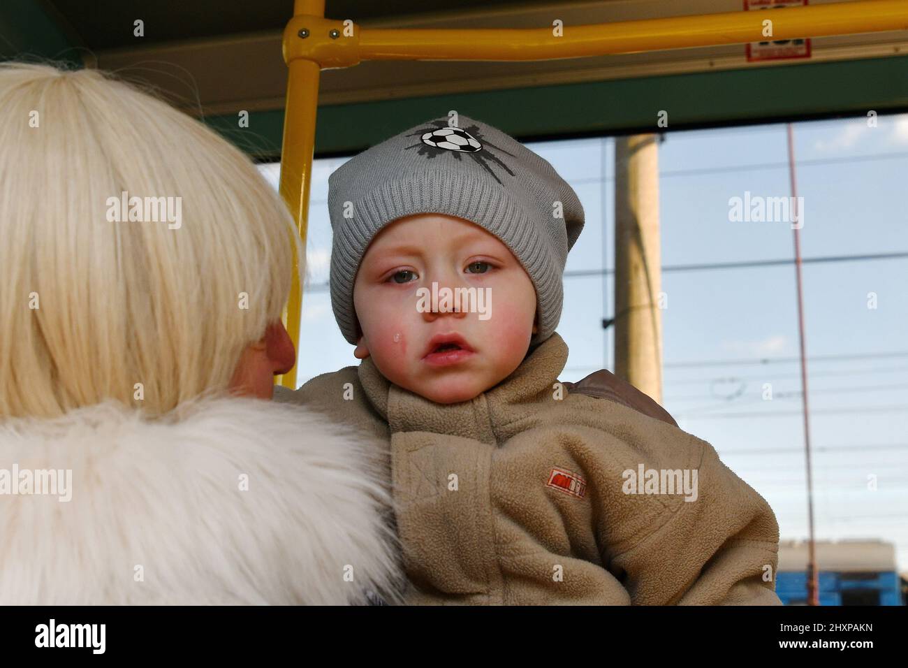 Kramatorsk, Ukraine. 13th Mar, 2022. A woman seen carrying a kid from ...