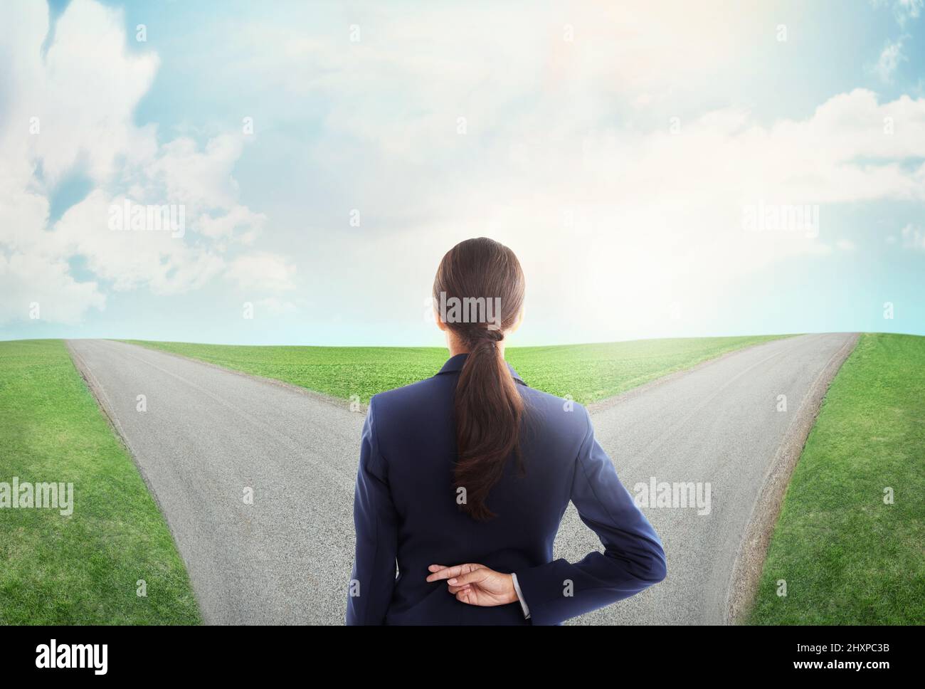 Crossroads - the choice is yours. Concept shot of a young businesswoman ...
