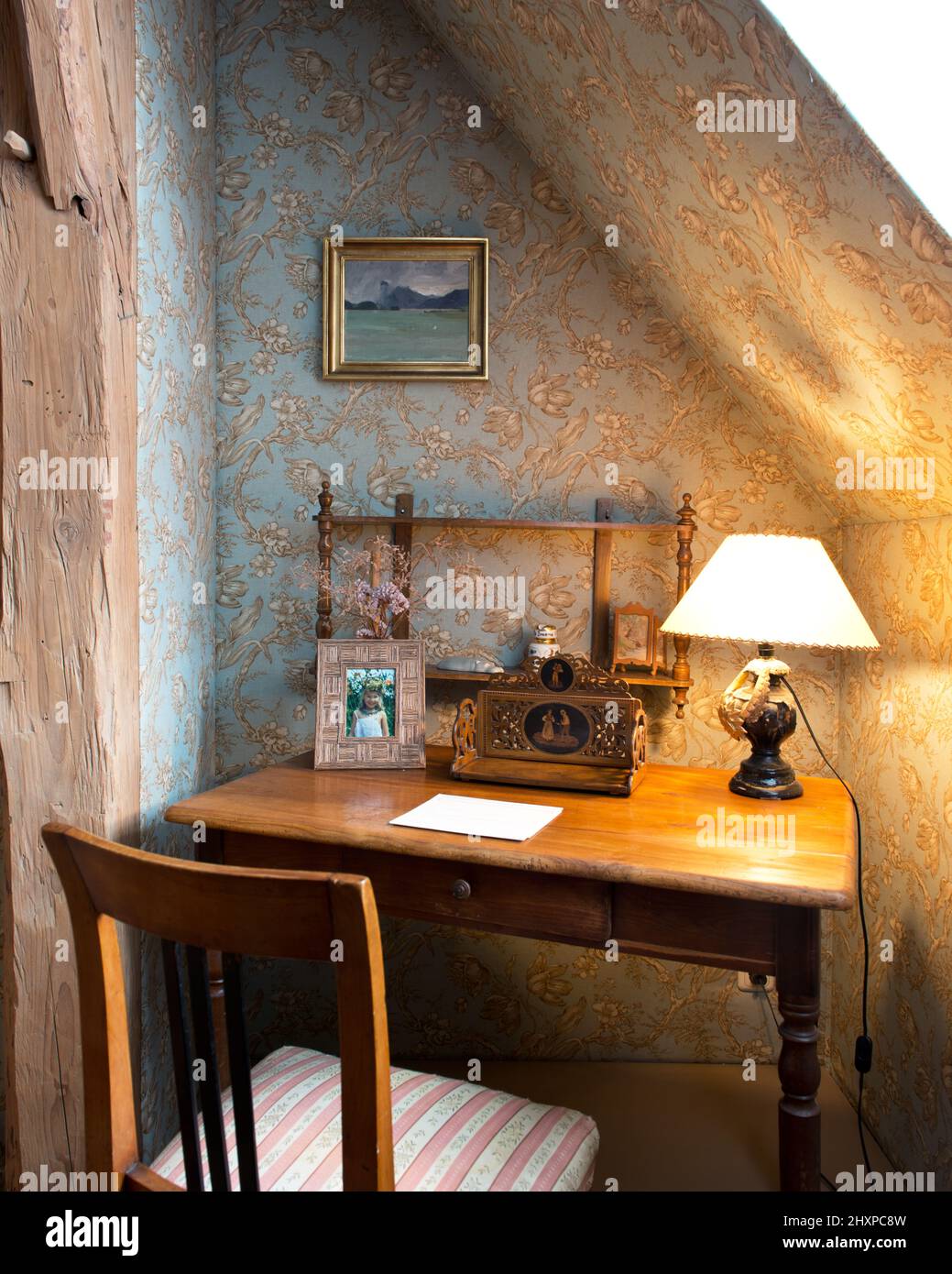 niche or alcove with blue and brown patterned wallpaper, old writing ...