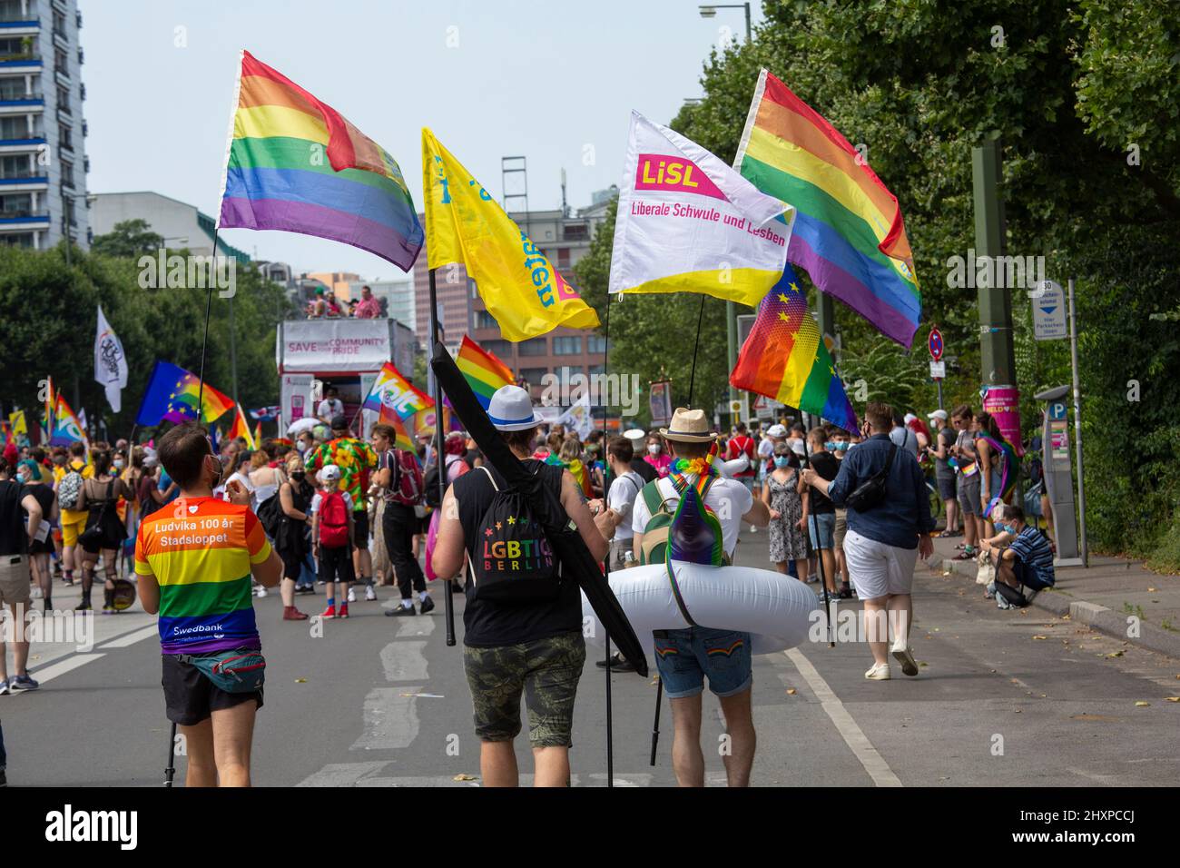 Participants with rainbow flags walk towards the start of the gay ...
