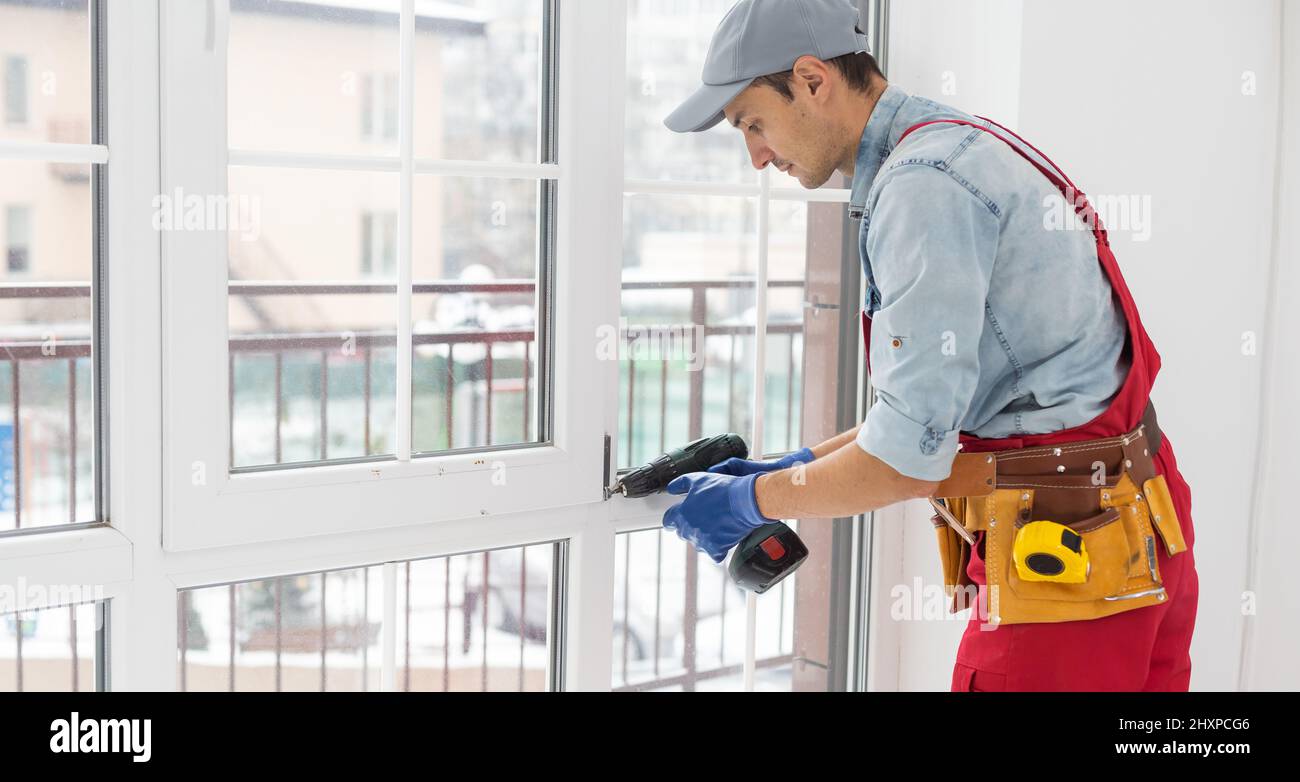 The worker installing and checking window in the house Stock Photo - Alamy