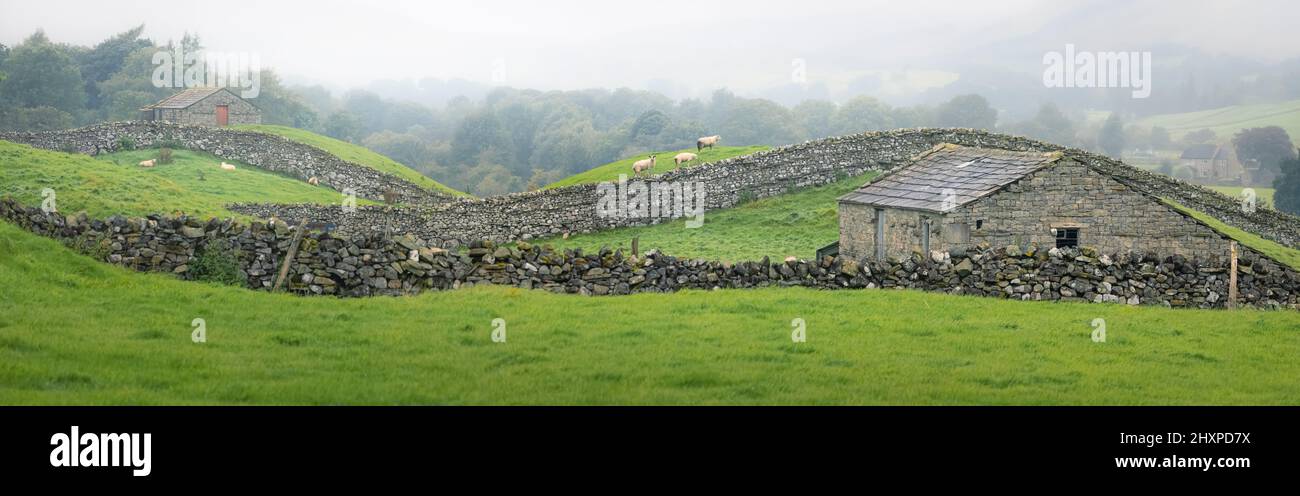 Wide panorama rural English countryside view of old stone walls, barns ...