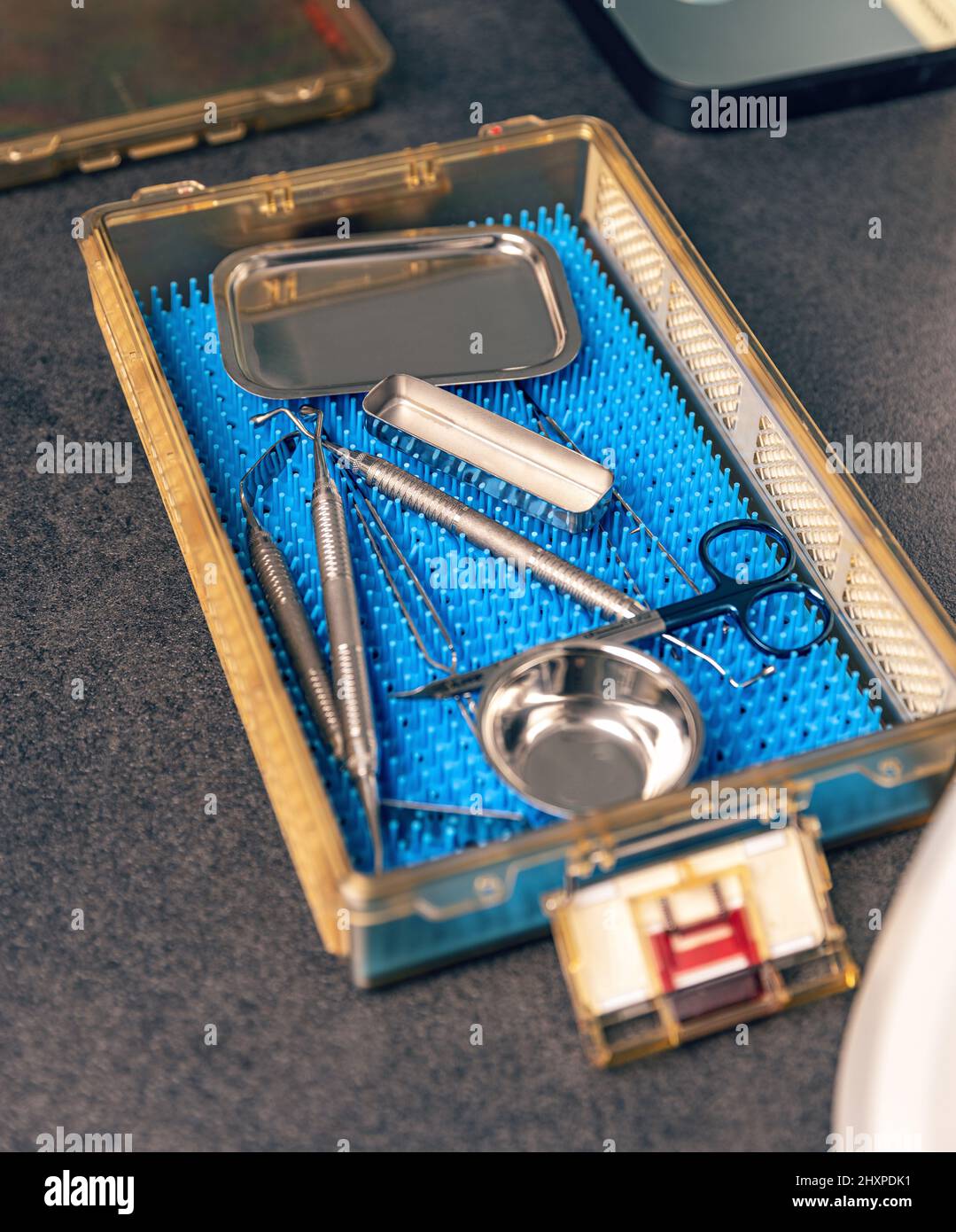 Metal dental instruments in a box. Set of tools for dental treatment ...