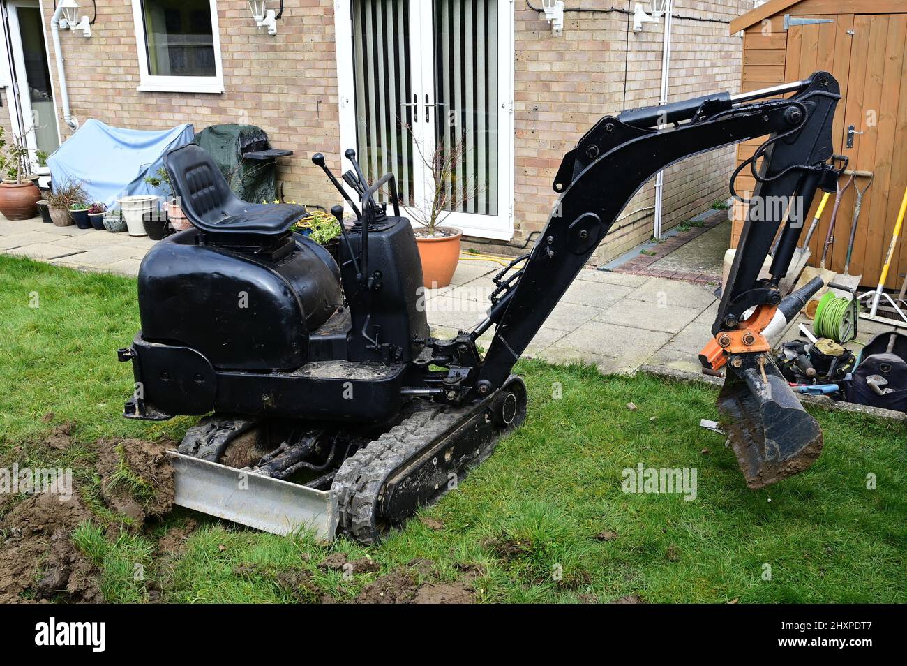 A small garden digger parked ready for use Stock Photo - Alamy