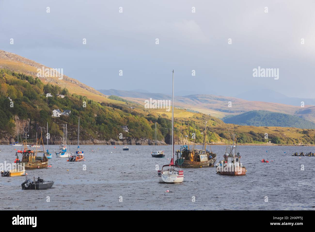 Ullapool, UK - September 28 2021: Fishing boats and sail boats moores ...