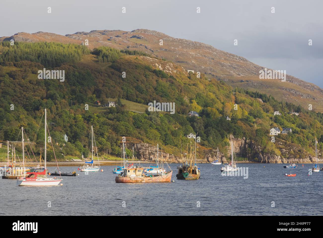 Ullapool, UK - September 28 2021: Fishing boats and sail boats moores ...