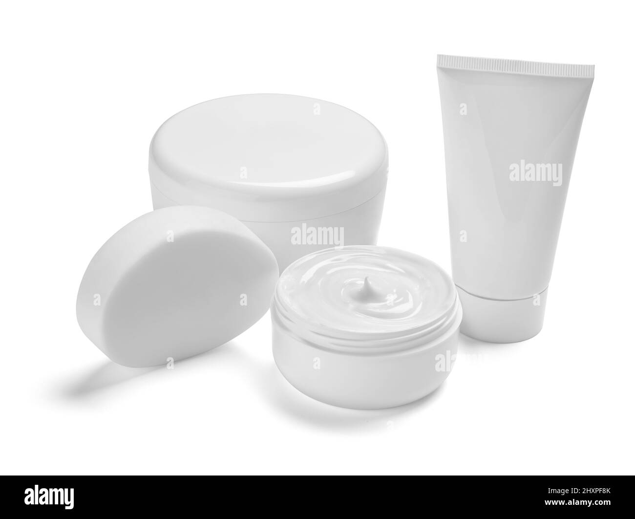 close up of a white beauty cream container and tube on white background ...