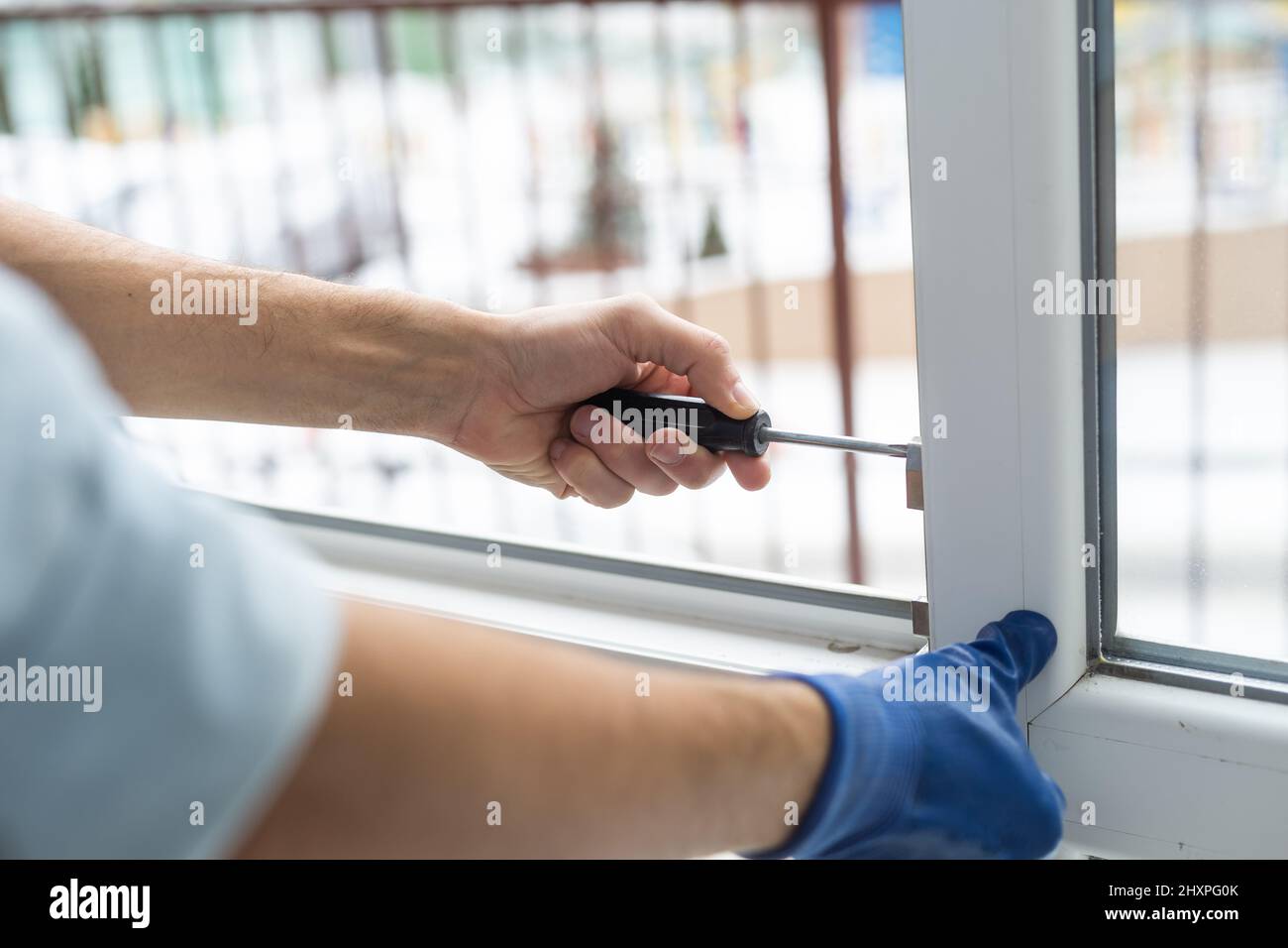 Construction worker installing window in house. Handyman fixing the ...
