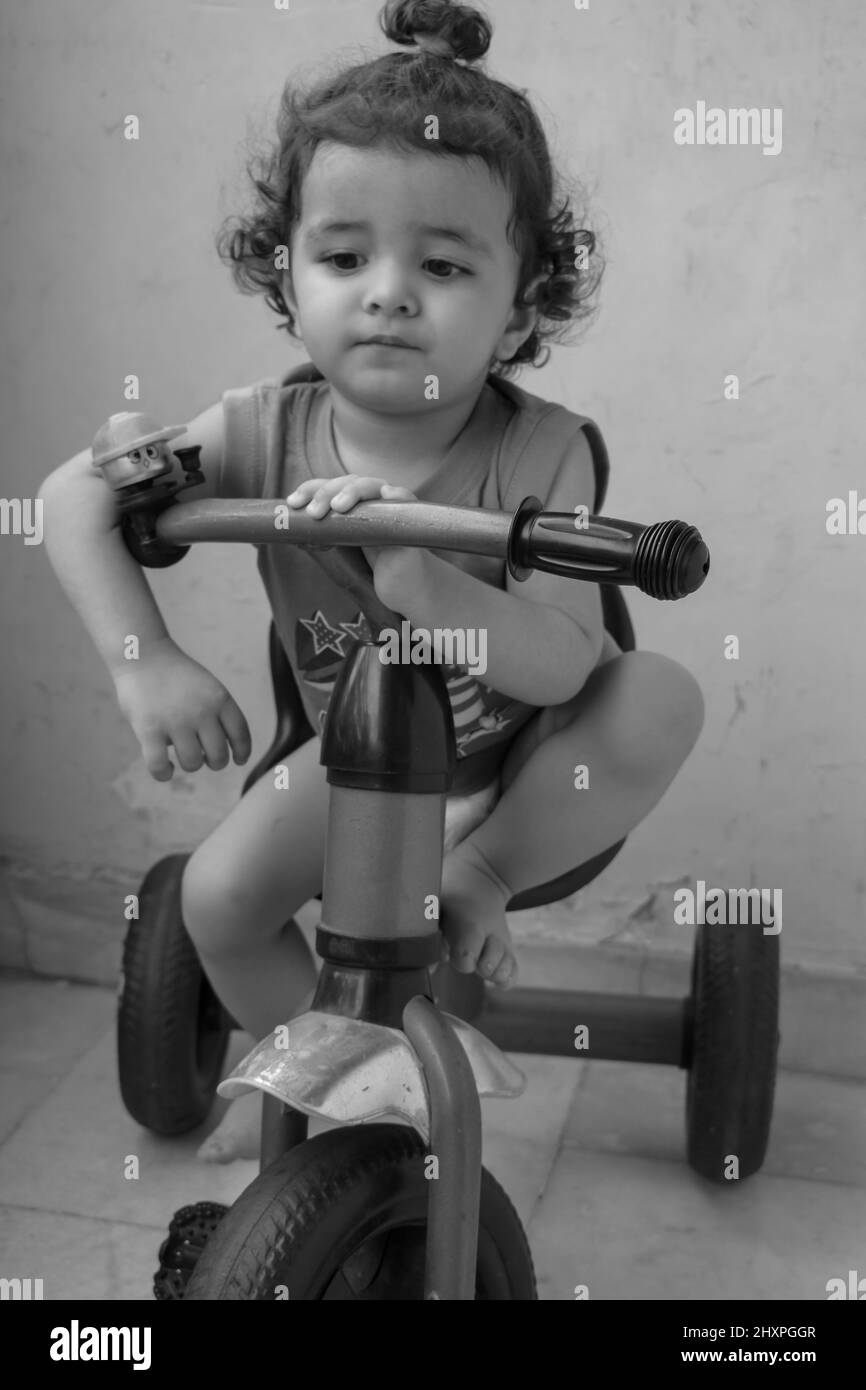 Cute little boy Shivaay driving cycle at home balcony during summer ...