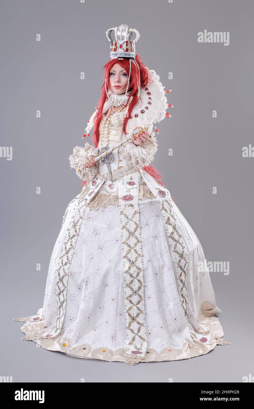 Queen wizard. Model dressed in renaissance style on gray background ...