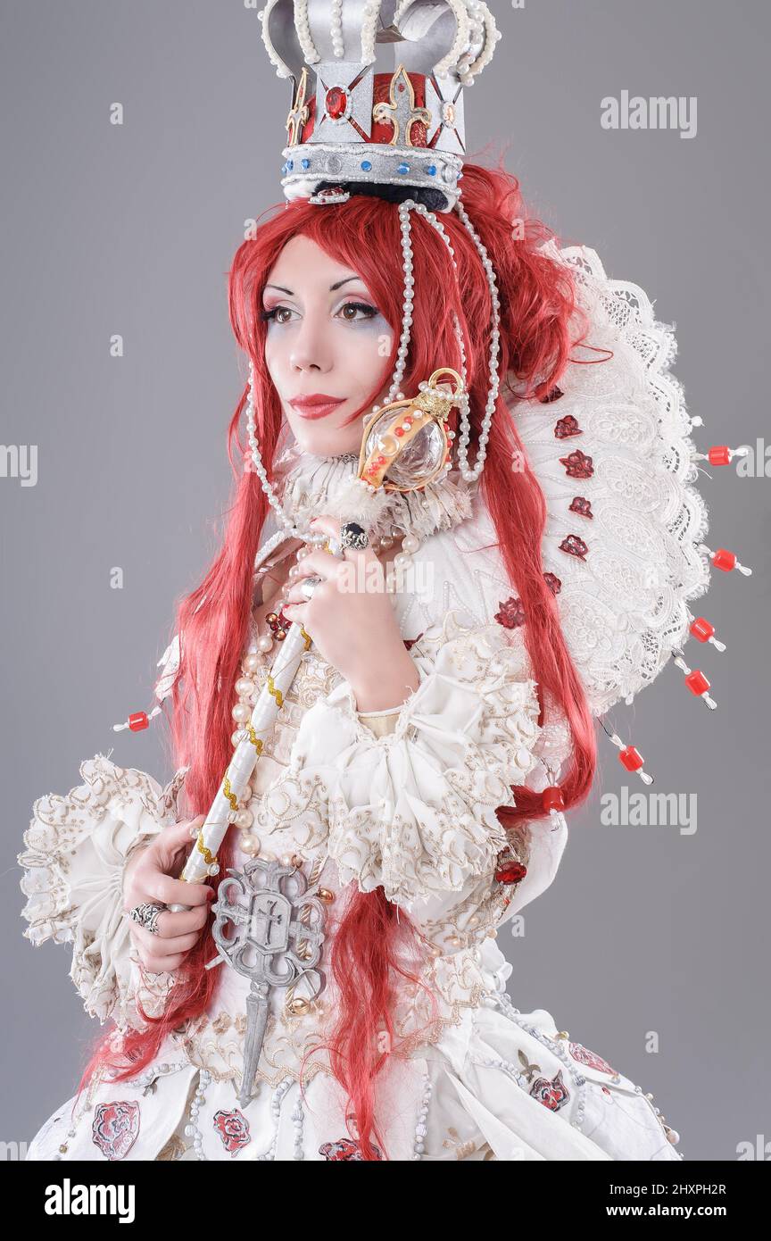 Queen wizard. Model dressed in renaissance style on gray background ...