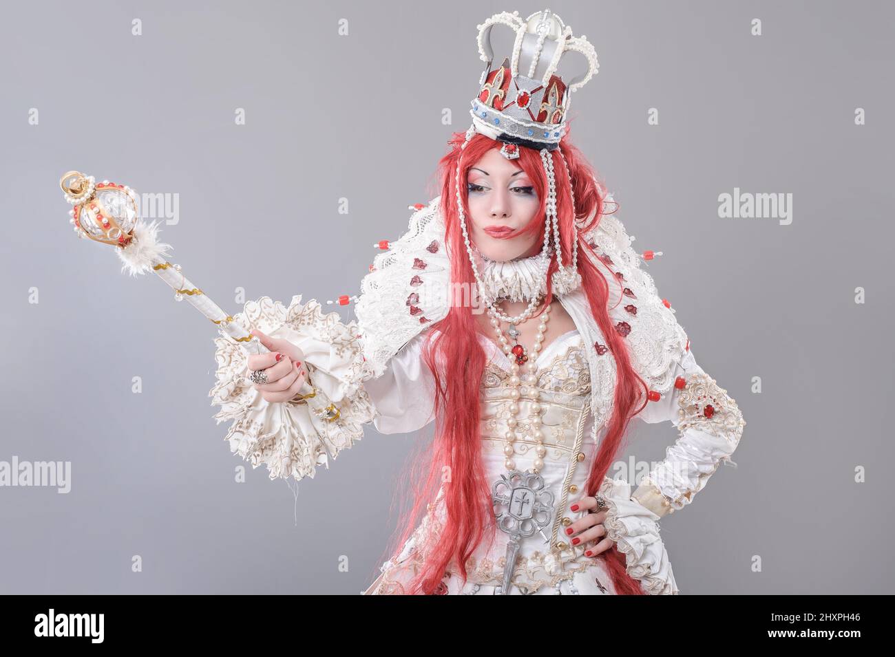 Queen wizard. Model dressed in renaissance style on gray background ...