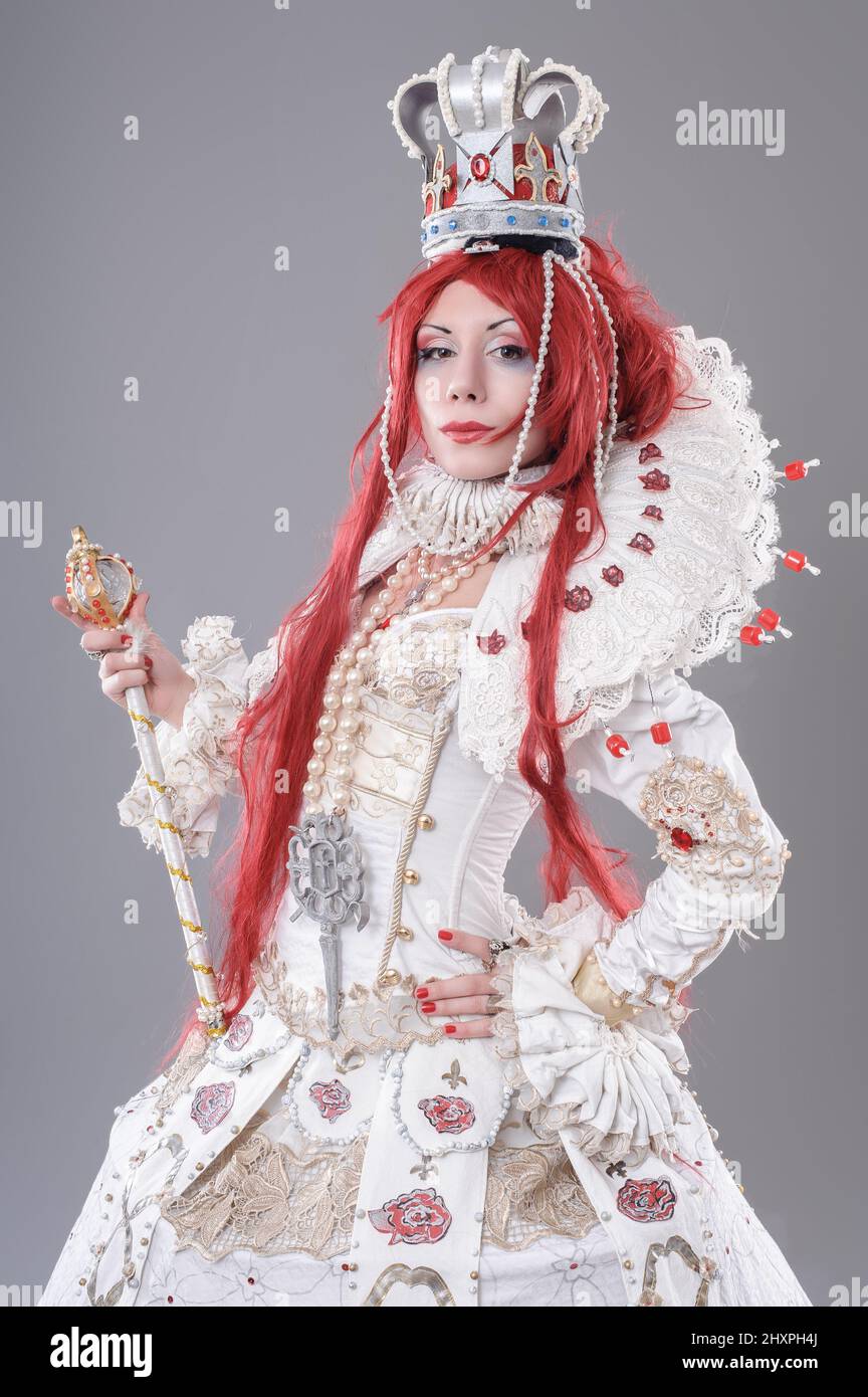 Queen wizard. Model dressed in renaissance style on gray background ...