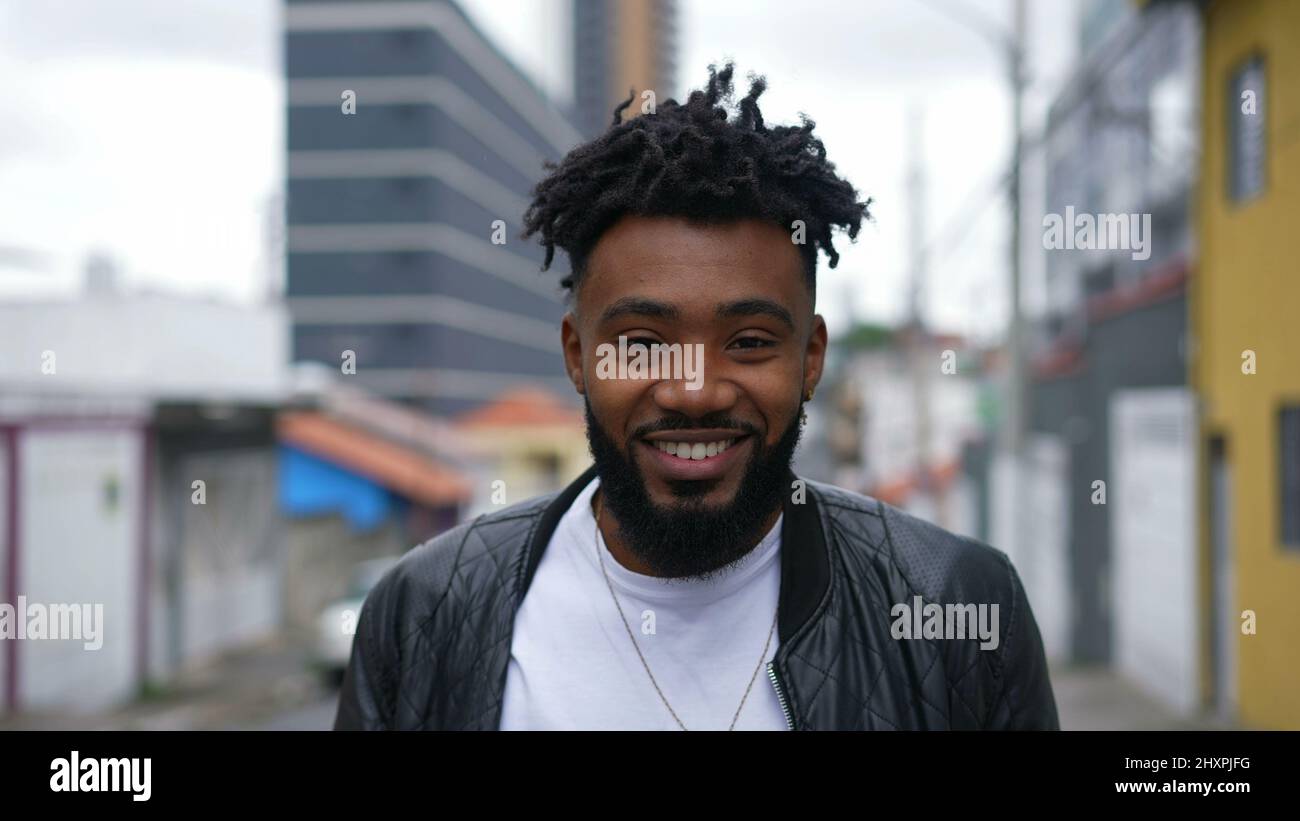 A happy young African man walking in urban street going forward Stock ...