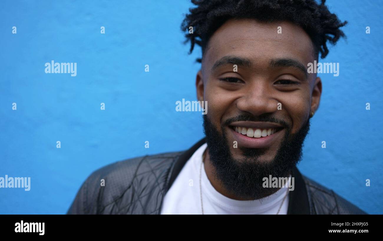 A happy young black man smiling portrait face one charismatic African ...