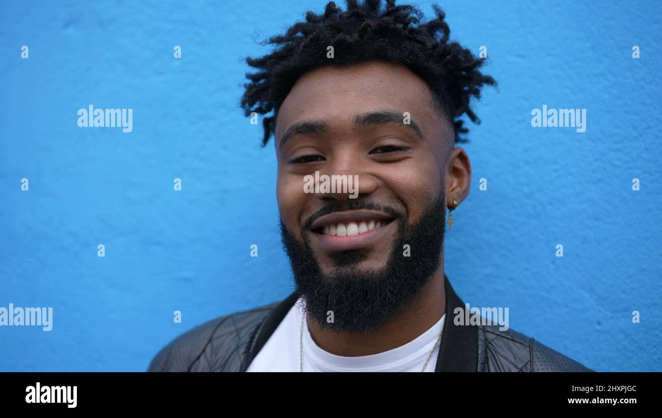 A happy young black man smiling portrait face one charismatic African ...