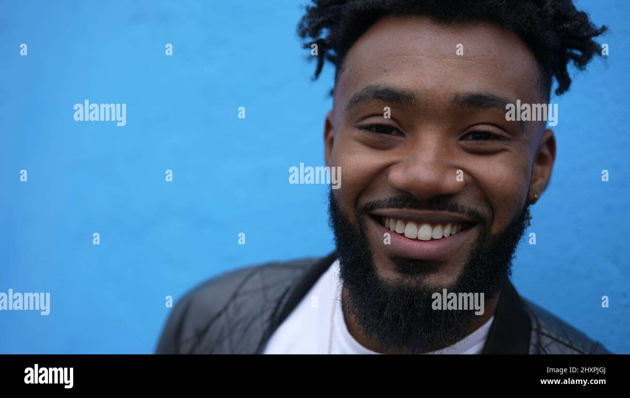 A happy young black man smiling portrait face one charismatic African ...