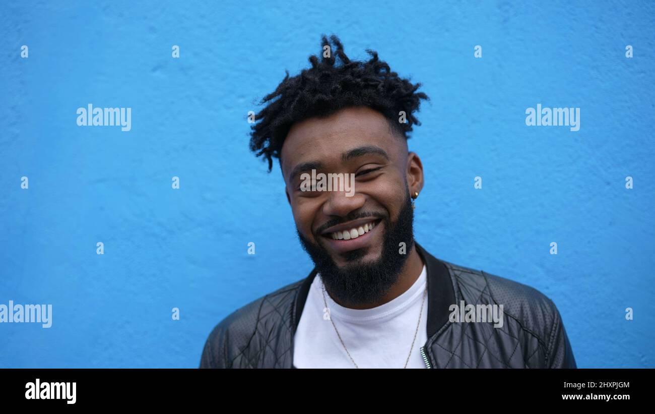 A happy young black man smiling portrait face one charismatic African ...