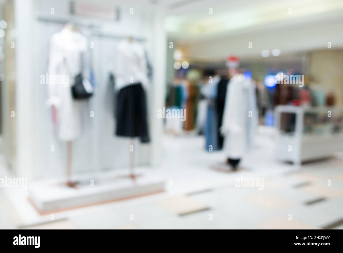 Blurred showcases fashion boutique Clothing store in a modern shopping ...