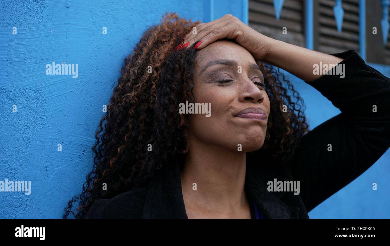 An Anxious African woman having difficult times feeling stressed out ...
