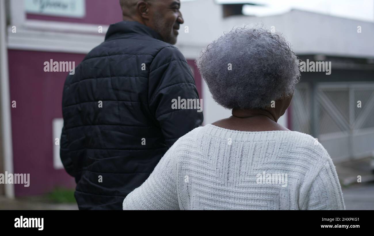 Generational relationship father and 80s mother walking together in ...