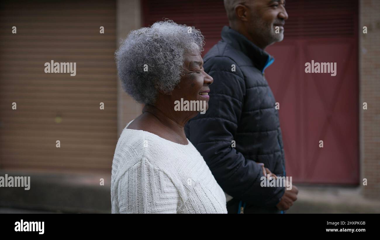 Generational relationship father and 80s mother walking together in ...